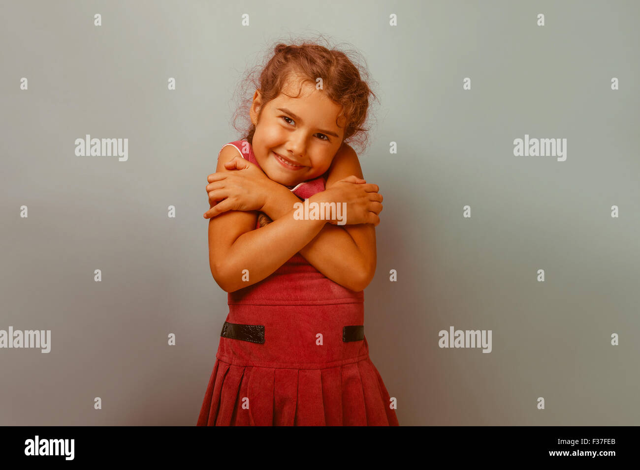 Girl European appearance decade hugging herself on a blue backg Stock ...