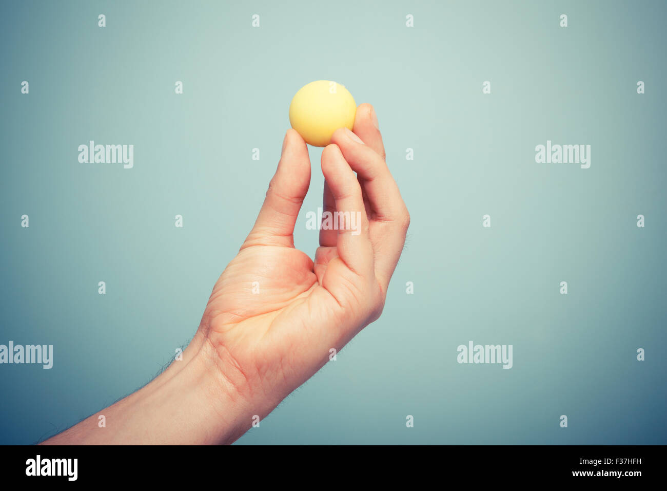 A hand is holding a small ball Stock Photo - Alamy