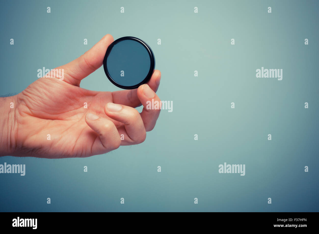 A hand is holding circular polarizer filter Stock Photo - Alamy