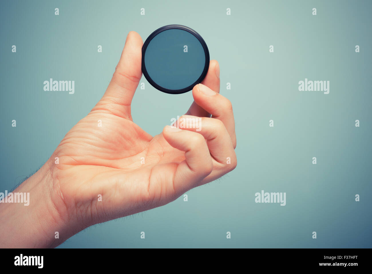 A hand is holding circular polarizer filter Stock Photo - Alamy