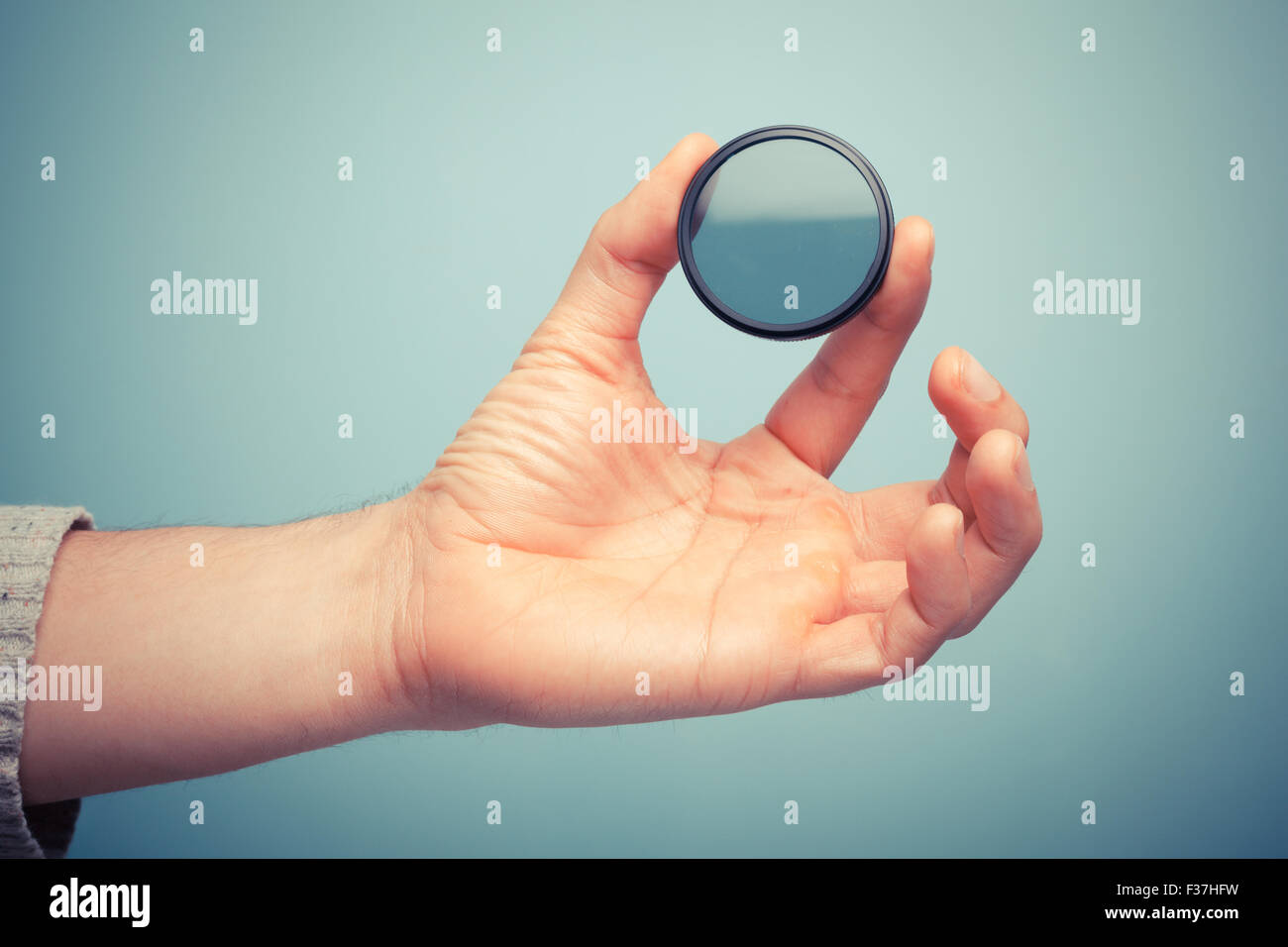 A hand is holding circular polarizer filter Stock Photo - Alamy