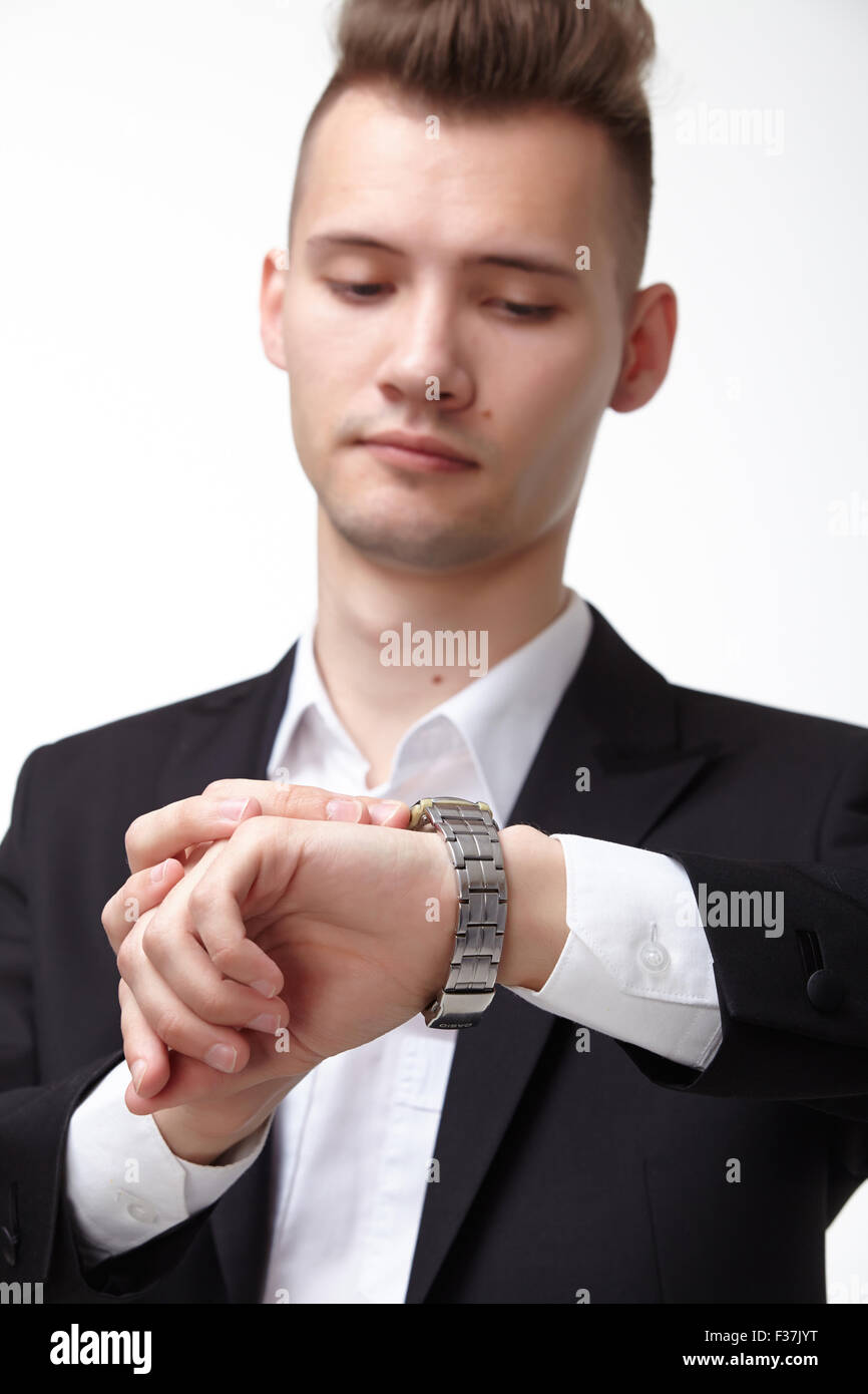 businessman in a suit looking at his watch Stock Photo - Alamy