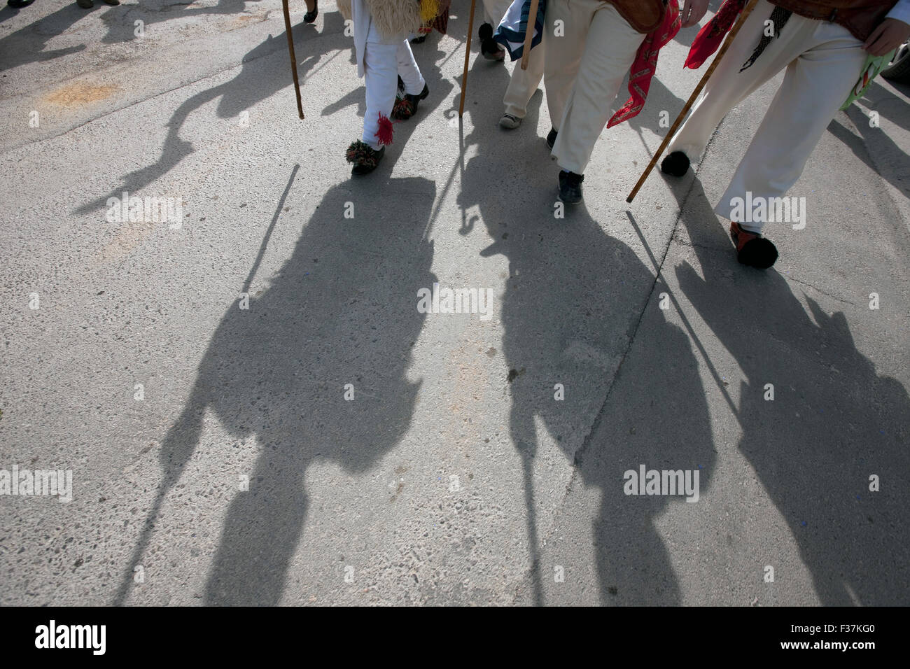 Vlachs and their shepherd crook shadows walk on street wearing Greek ...