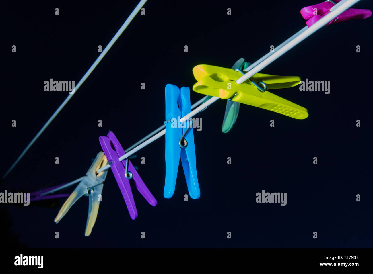 Brightly coloured close pegs on a washing line Stock Photo - Alamy