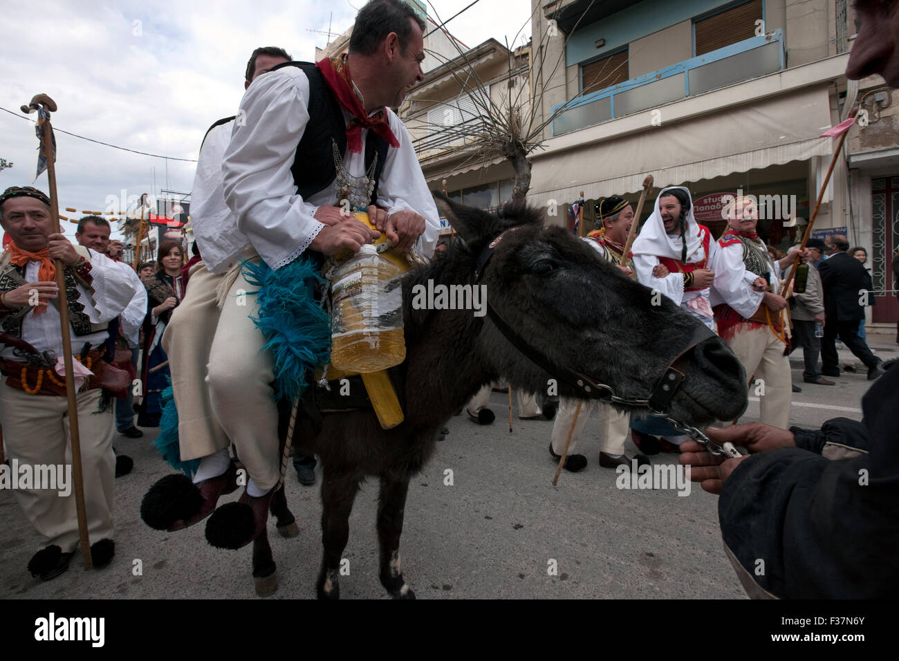Vlachs on a two-some donkey ride carry their wine in merrymaking mood ...