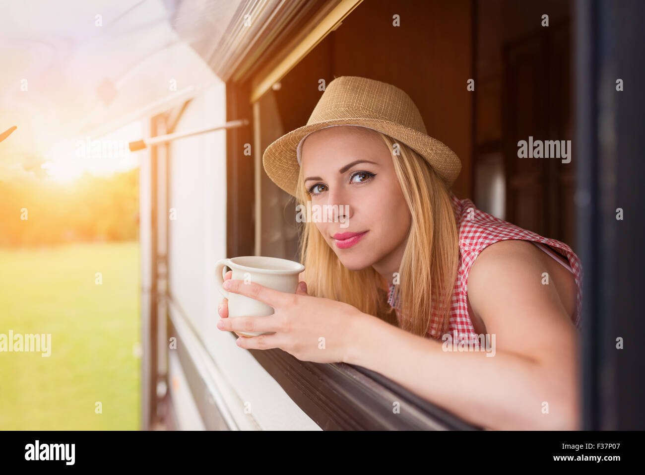 Beautiful woman in a camper van Stock Photo - Alamy