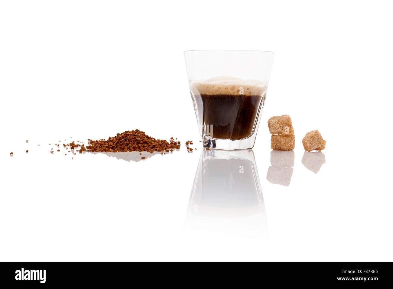 Instant coffee powder and delicious aromatic coffee in glass isolated ...