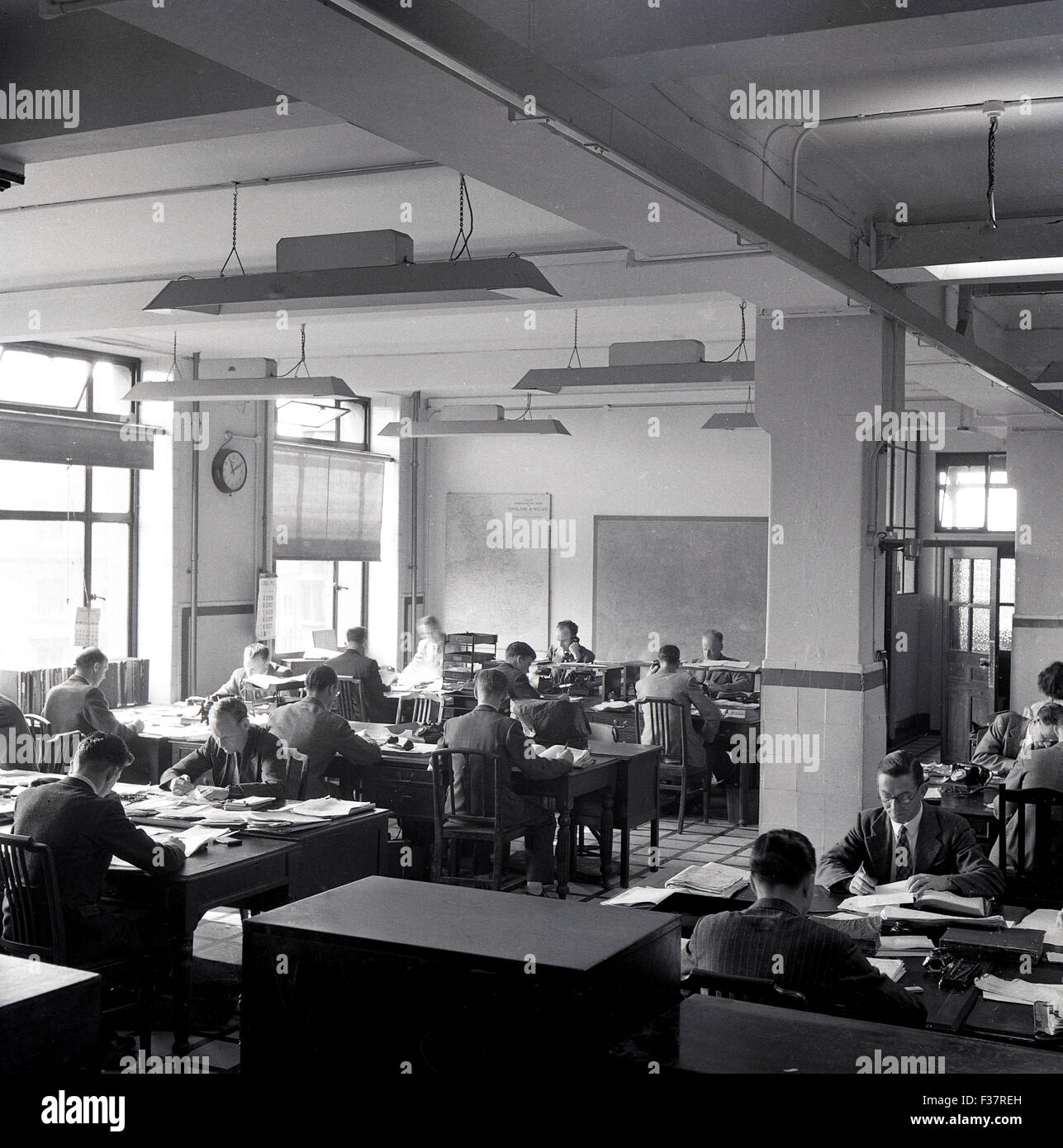 Historical, 1950s, picture showing an open plan office with staff at ...