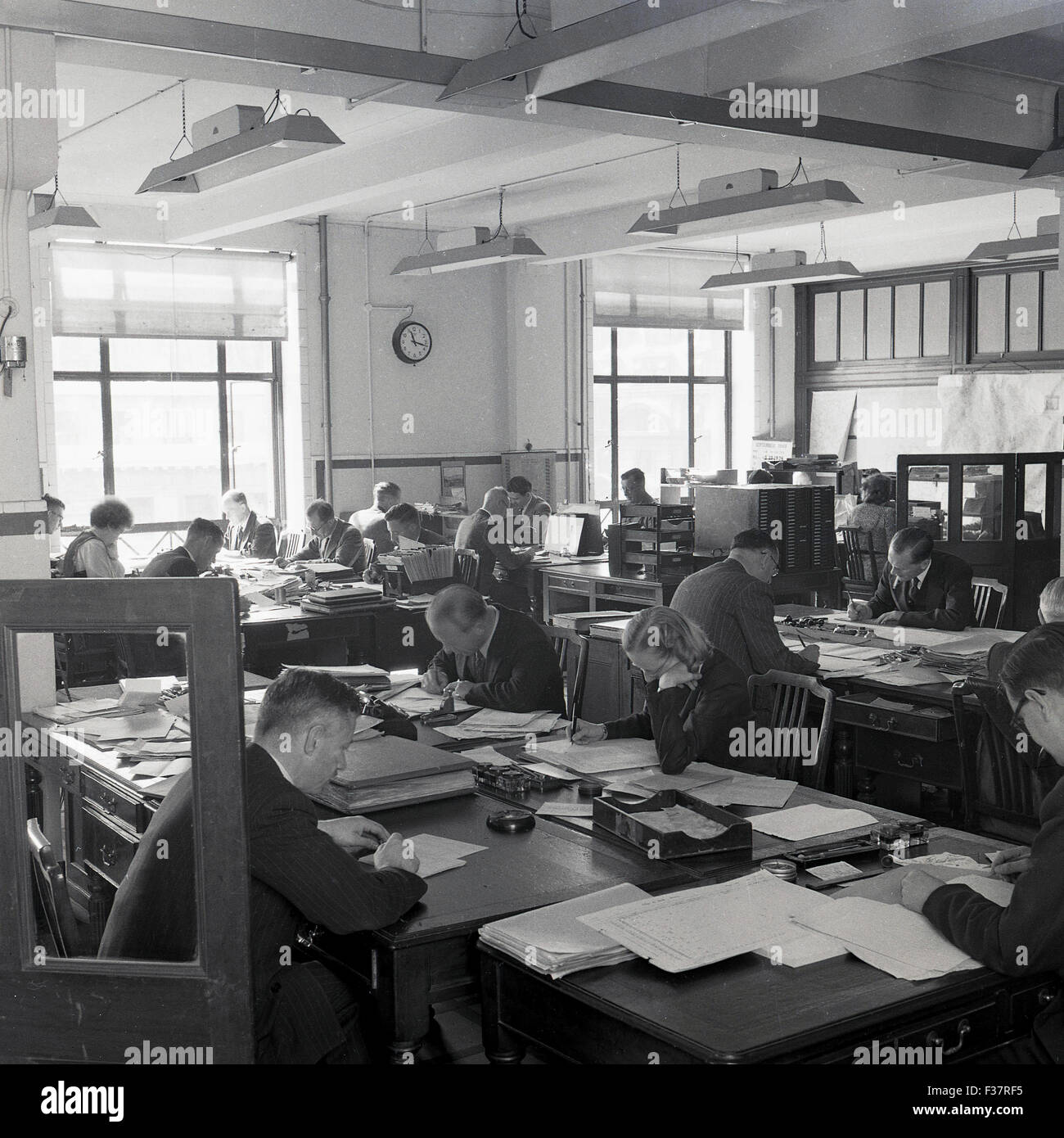 Historical, 1950s, picture showing an open plan office with staff at ...