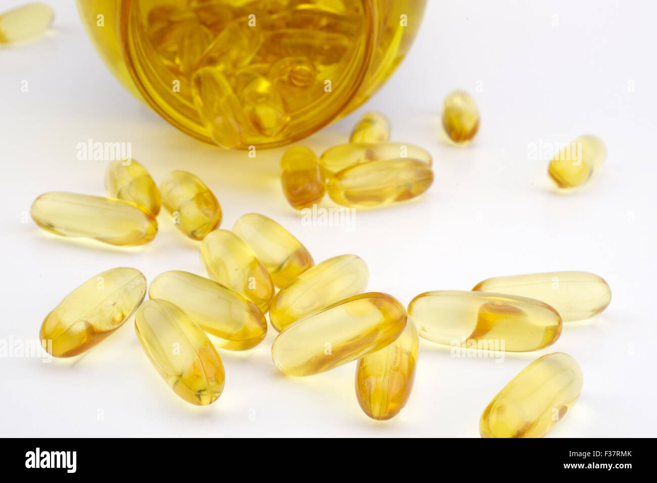 Fish oil and bottle on white background Stock Photo - Alamy