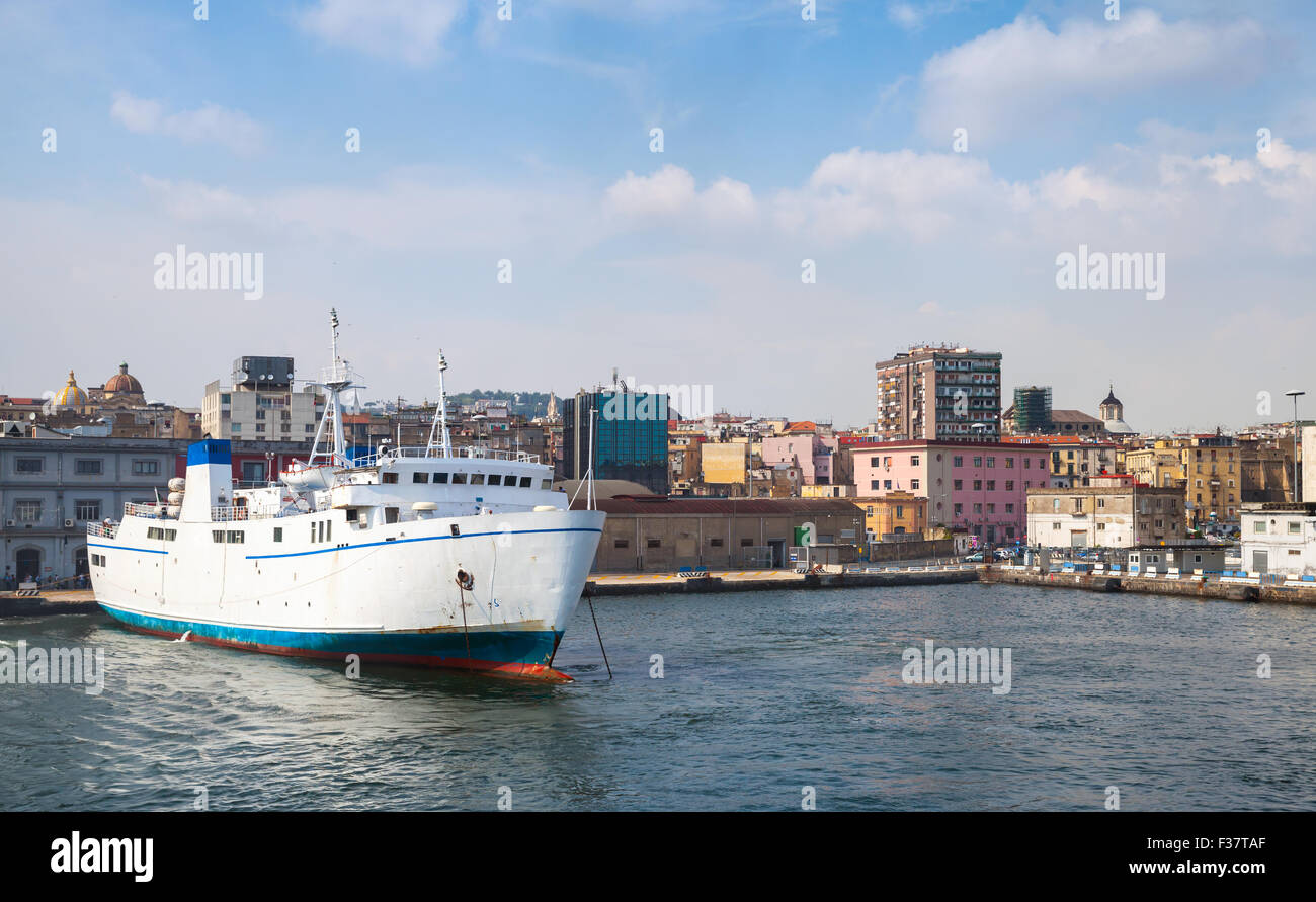 Port of Naples, coastal cityscape with white passenger ferry Stock ...