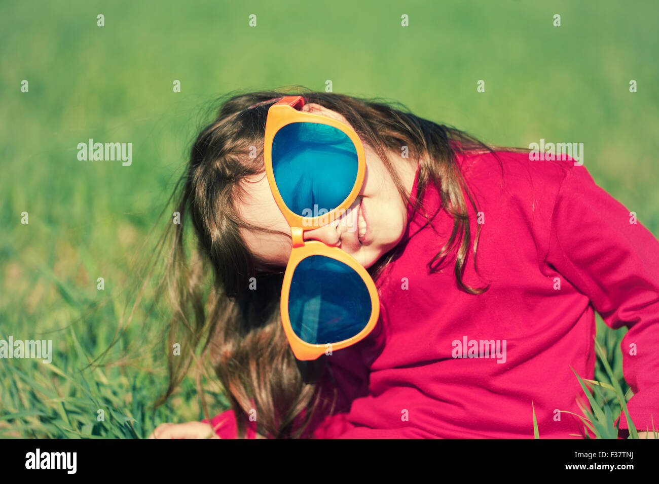 Happy smiling little girl wearing big sunglasses in the field Stock ...