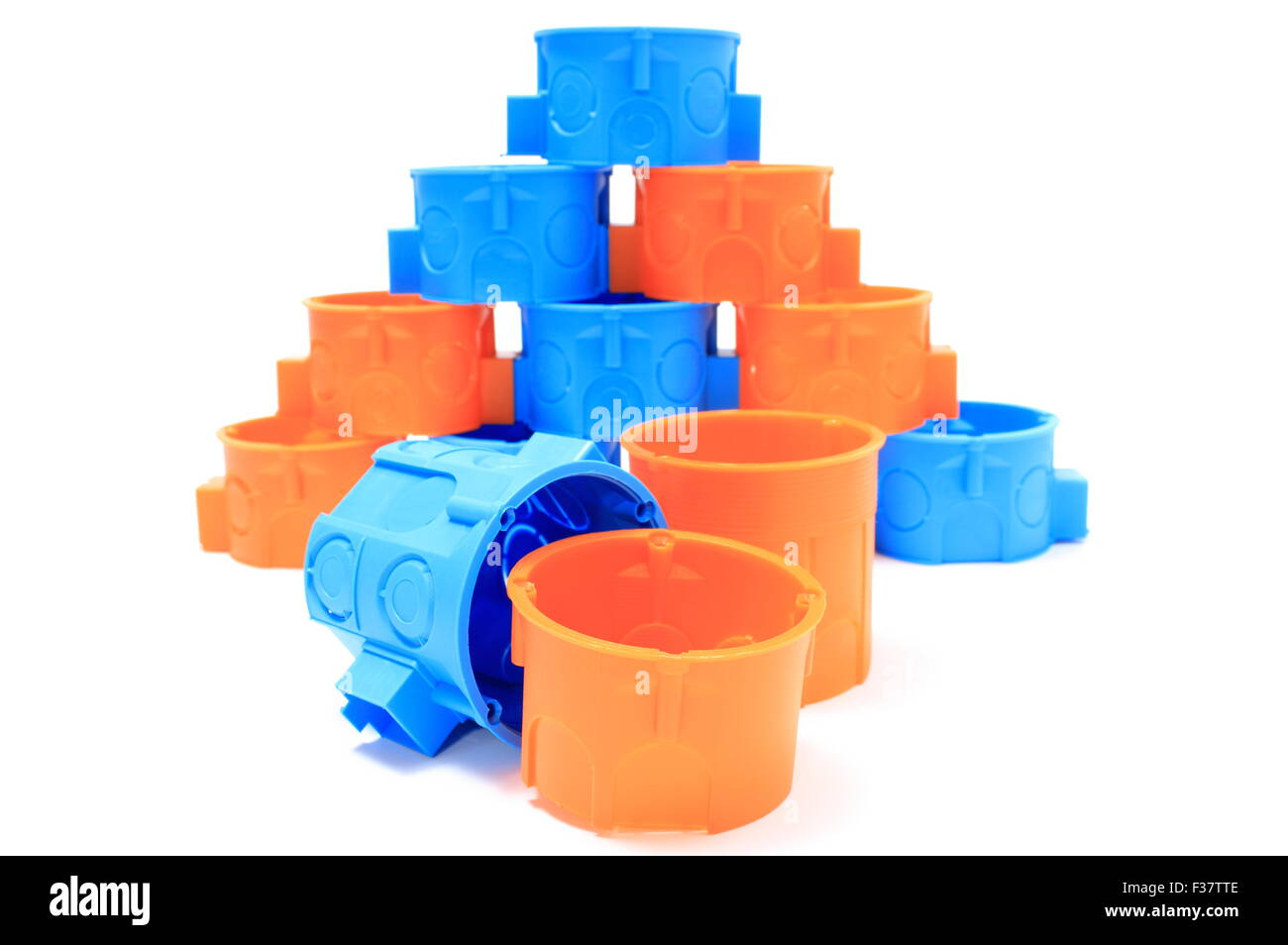 Blue and orange plastic electrical boxes on white background ...
