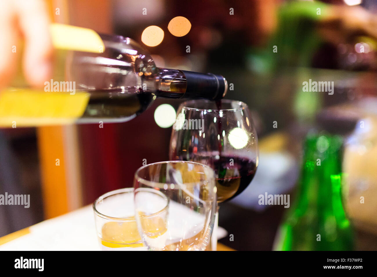 Pouring red wine into the glass Stock Photo - Alamy