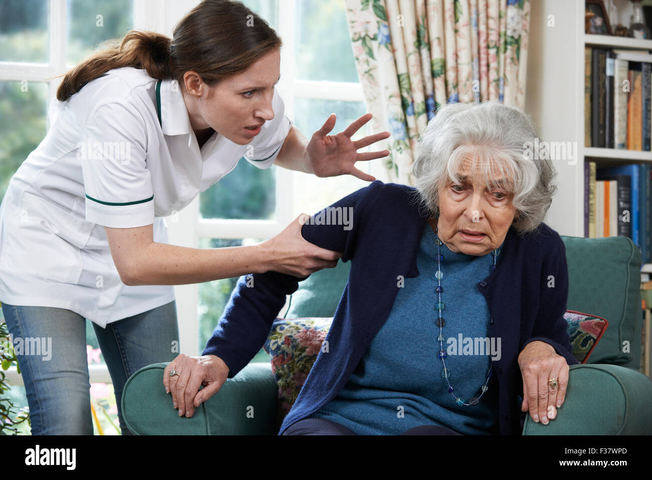 Care Worker Mistreating Senior Woman At Home Stock Photo - Alamy