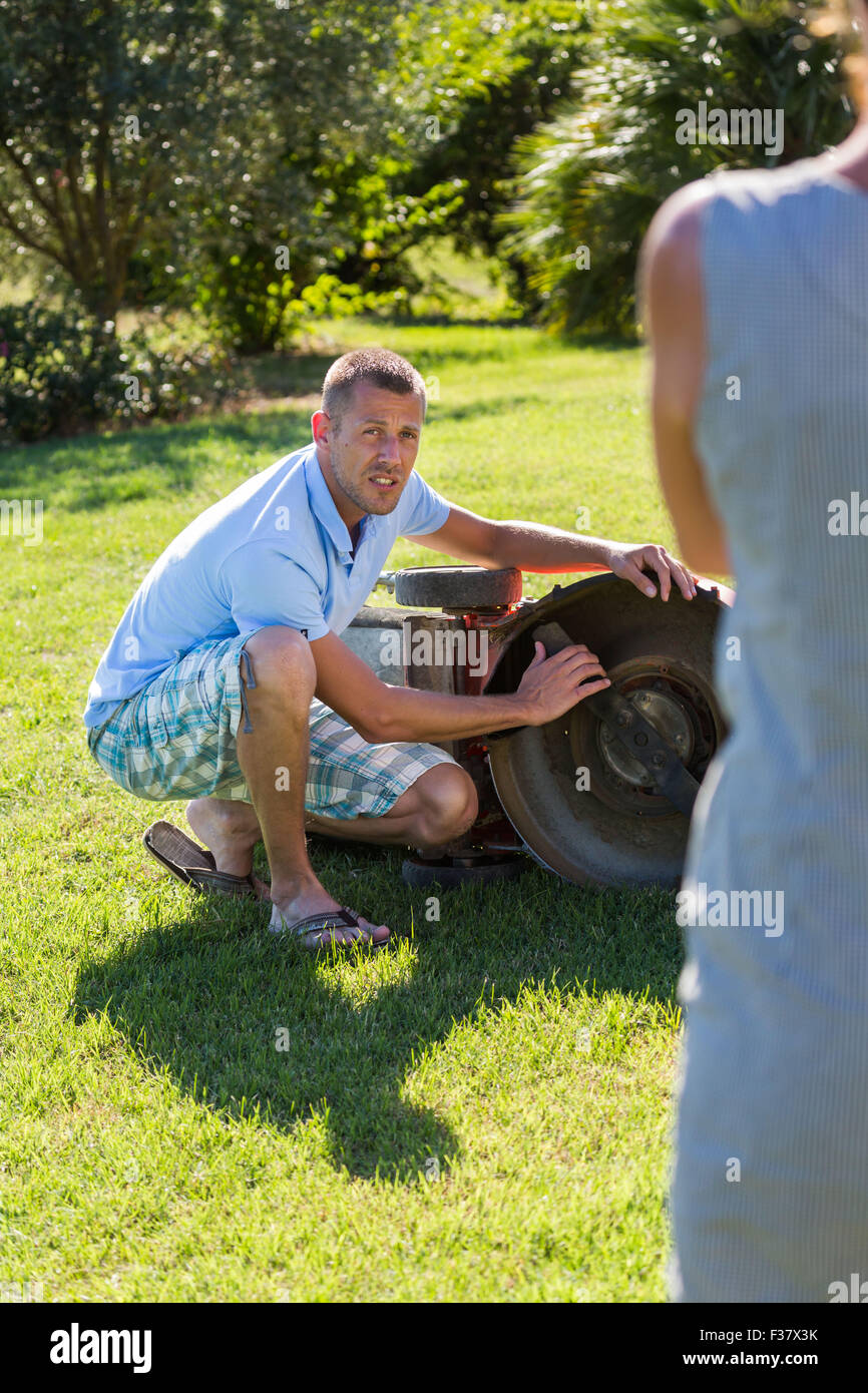 Man using a lawn mower Stock Photo - Alamy