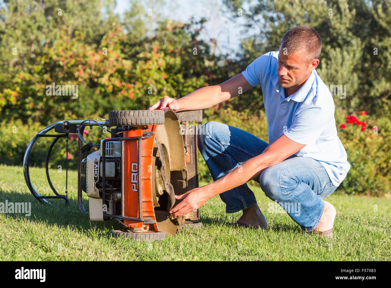 Man using a lawn mower Stock Photo - Alamy