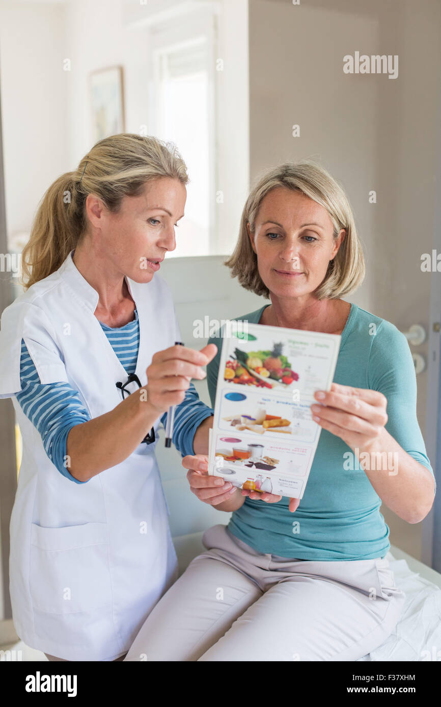 Woman receiving nutrition education consultation with dietician Stock ...