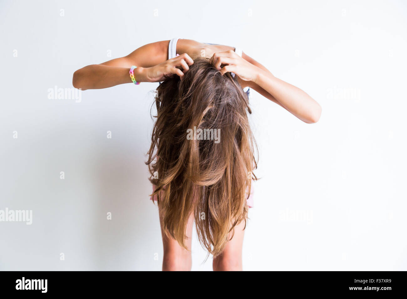 Girl scratching head Stock Photo - Alamy
