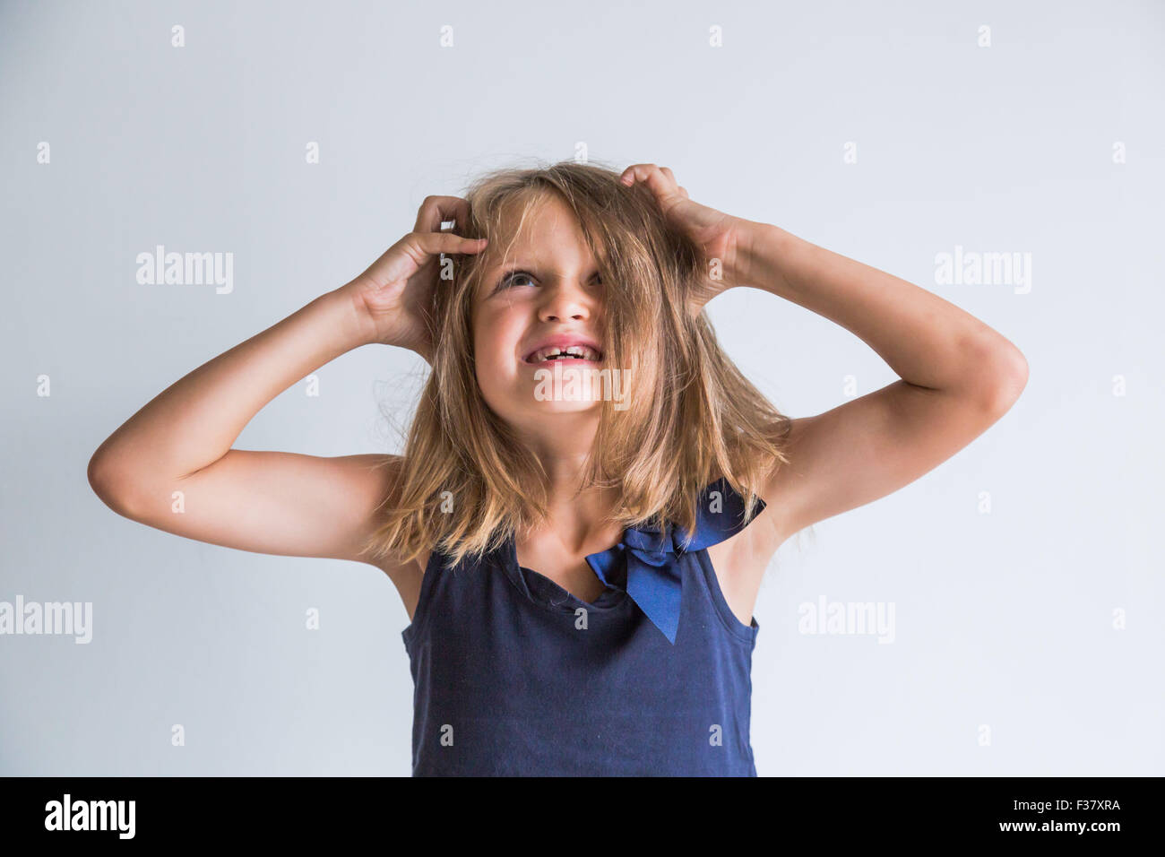 Girl scratching head Stock Photo - Alamy