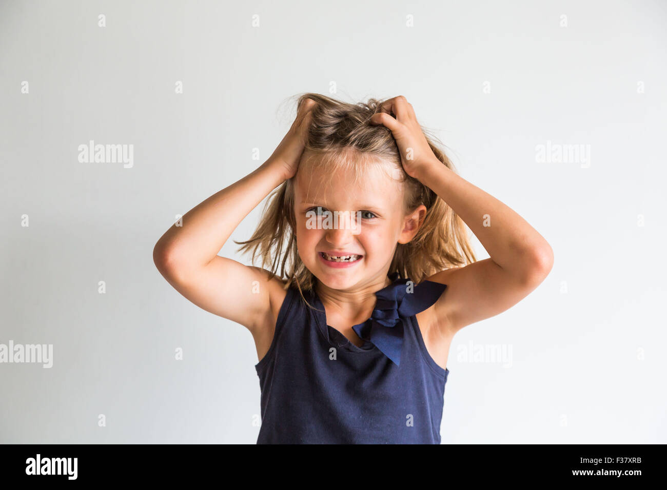Girl scratching head Stock Photo - Alamy