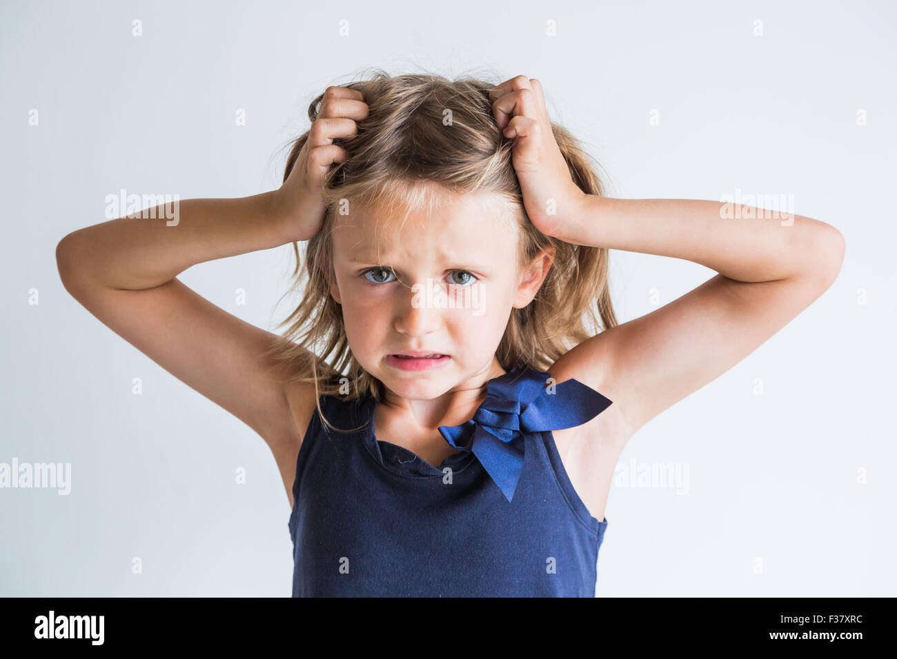 Girl scratching head Stock Photo - Alamy