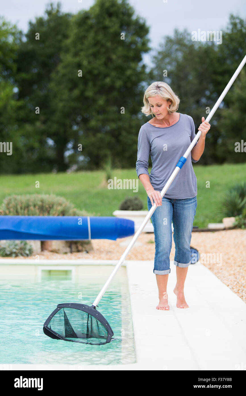 Woman cleaning swimming pool hi-res stock photography and images - Alamy