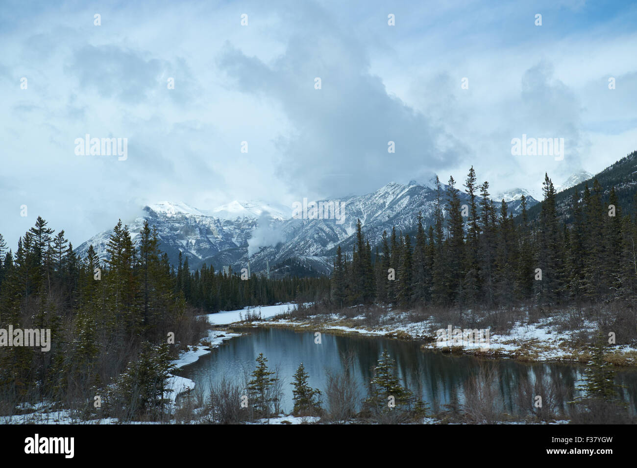 Canadian winter landscape with the Rockies Mountains and a lake with ...
