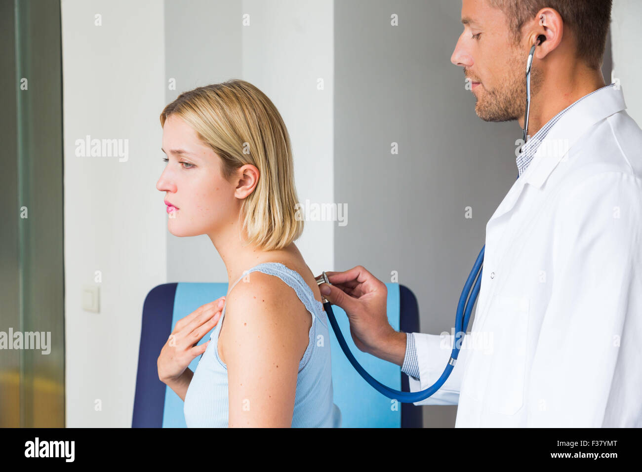 Doctor examining a patient with a stethoscope Stock Photo - Alamy