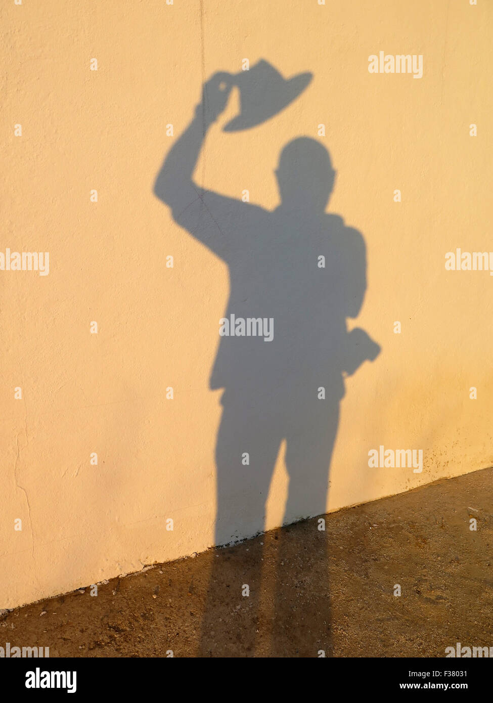 Photographer's shadow against plain concrete wall Stock Photo - Alamy