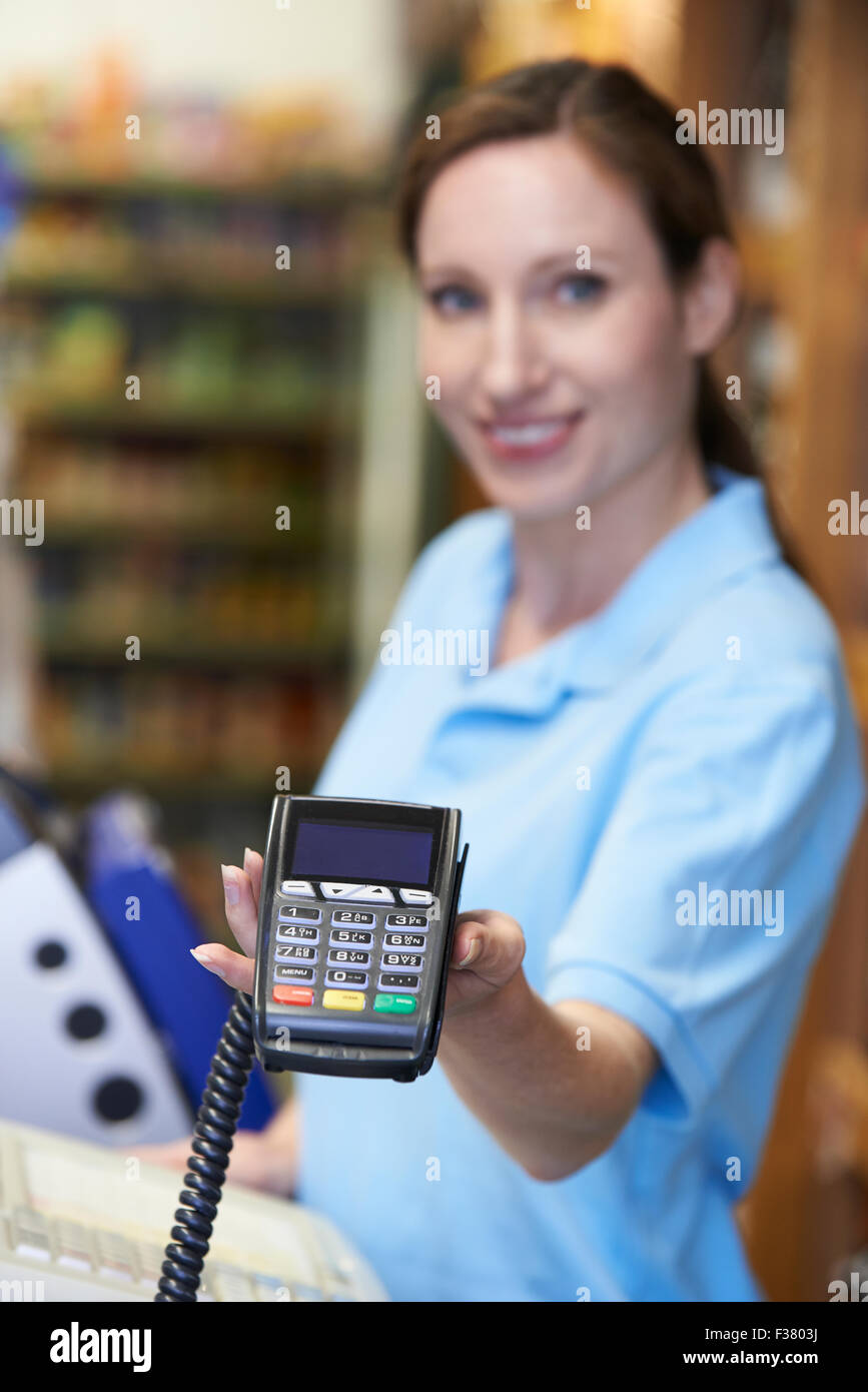 Female Sales Assistant Holding Credit Card Machine Stock Photo - Alamy