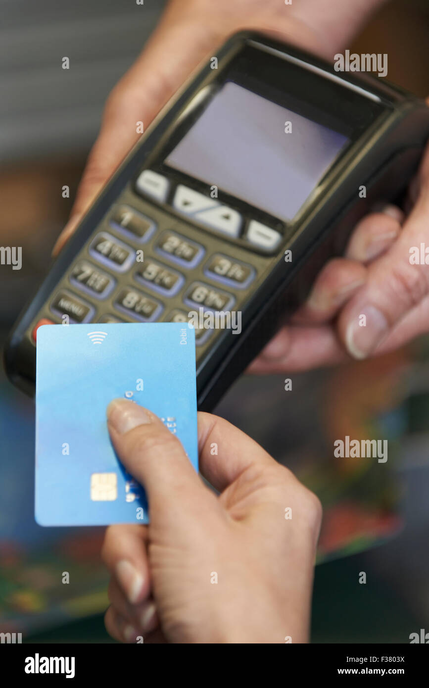 One woman paying credit card machine hi-res stock photography and ...