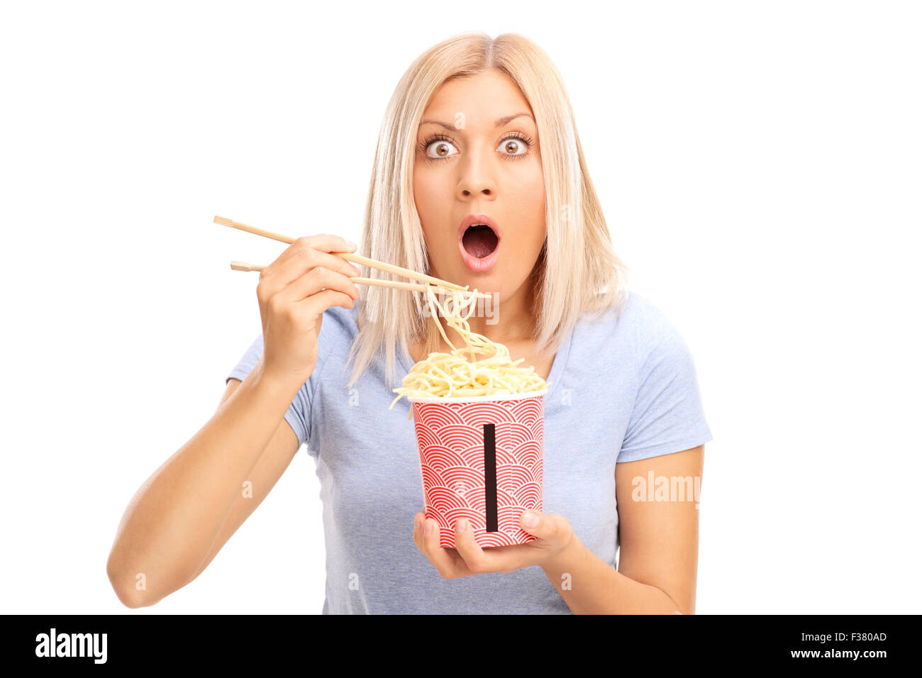 Surprised young woman eating chinese hi-res stock photography and ...