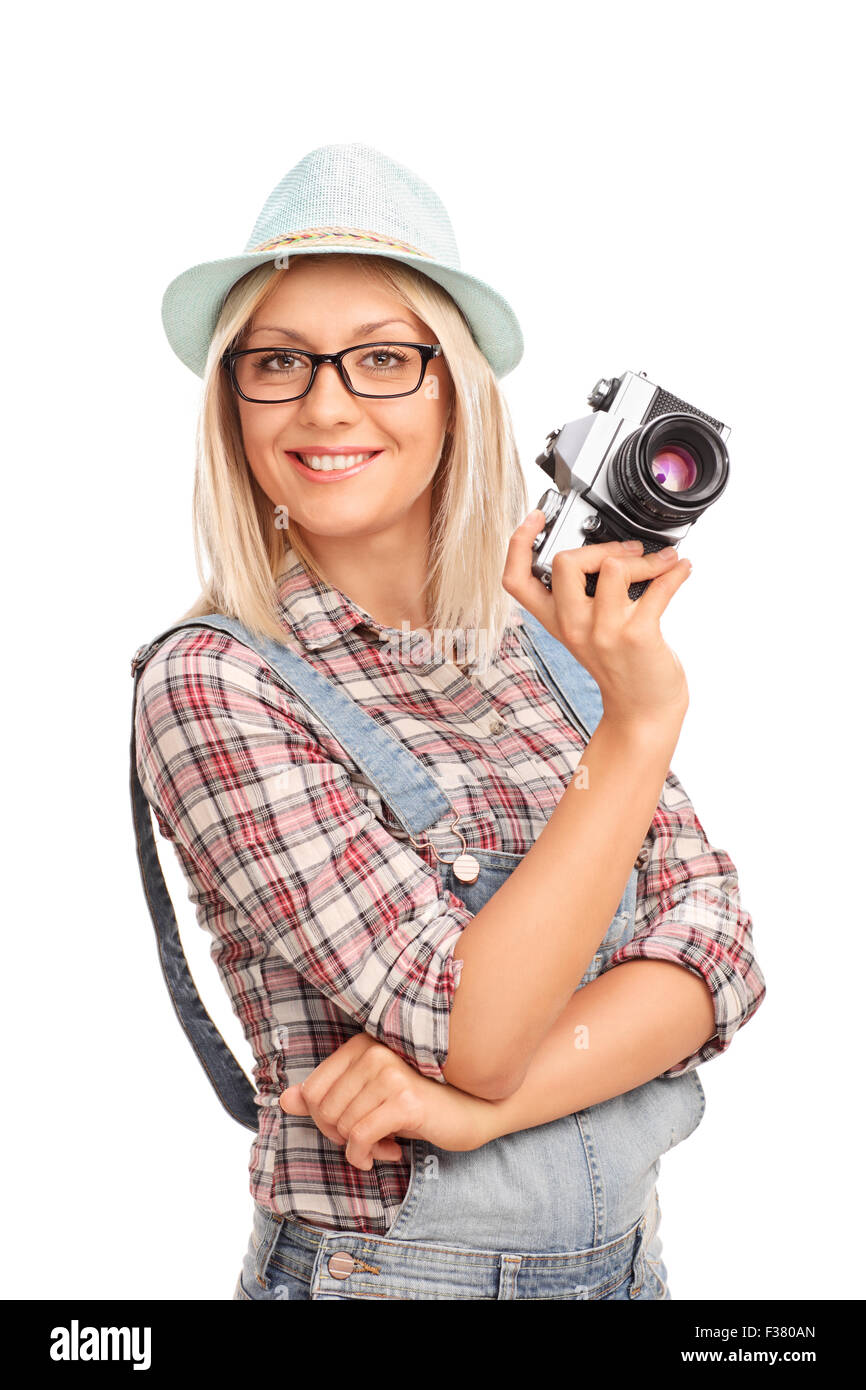 Vertical shot of a beautiful female photographer with blue cap holding ...