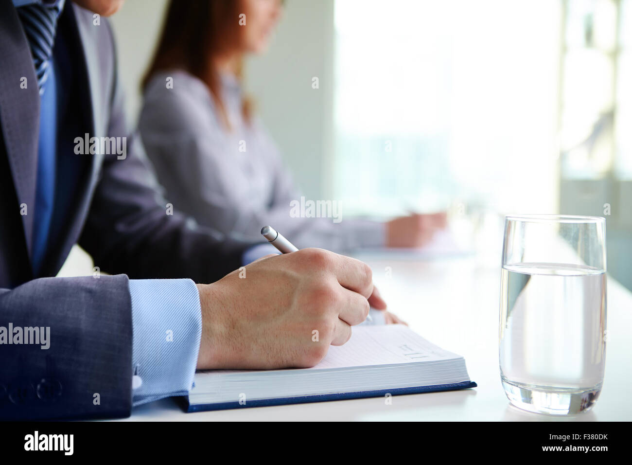 Male hand with pen writing in notebook Stock Photo - Alamy