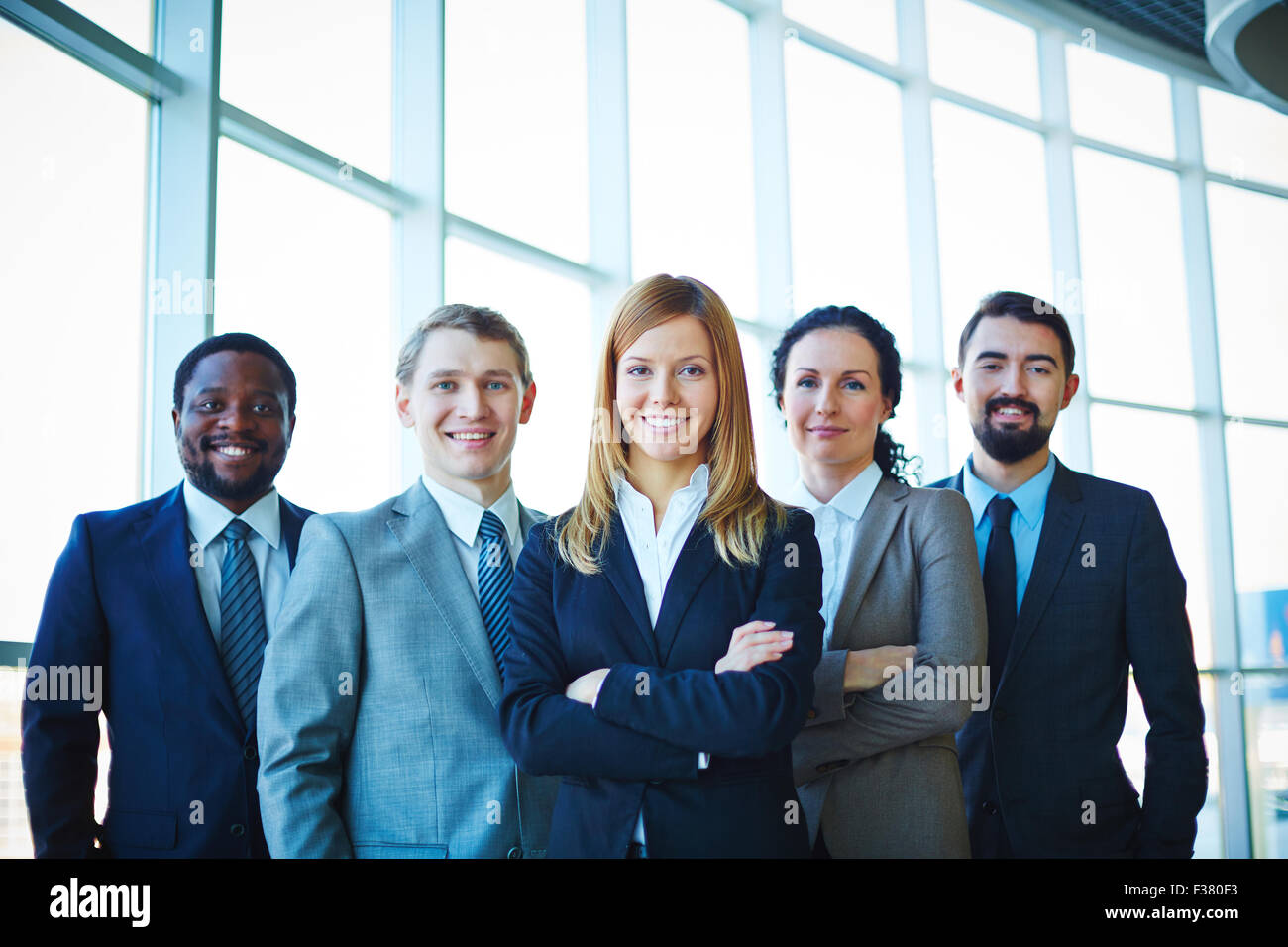 Successful business partners looking at camera with smiles Stock Photo ...