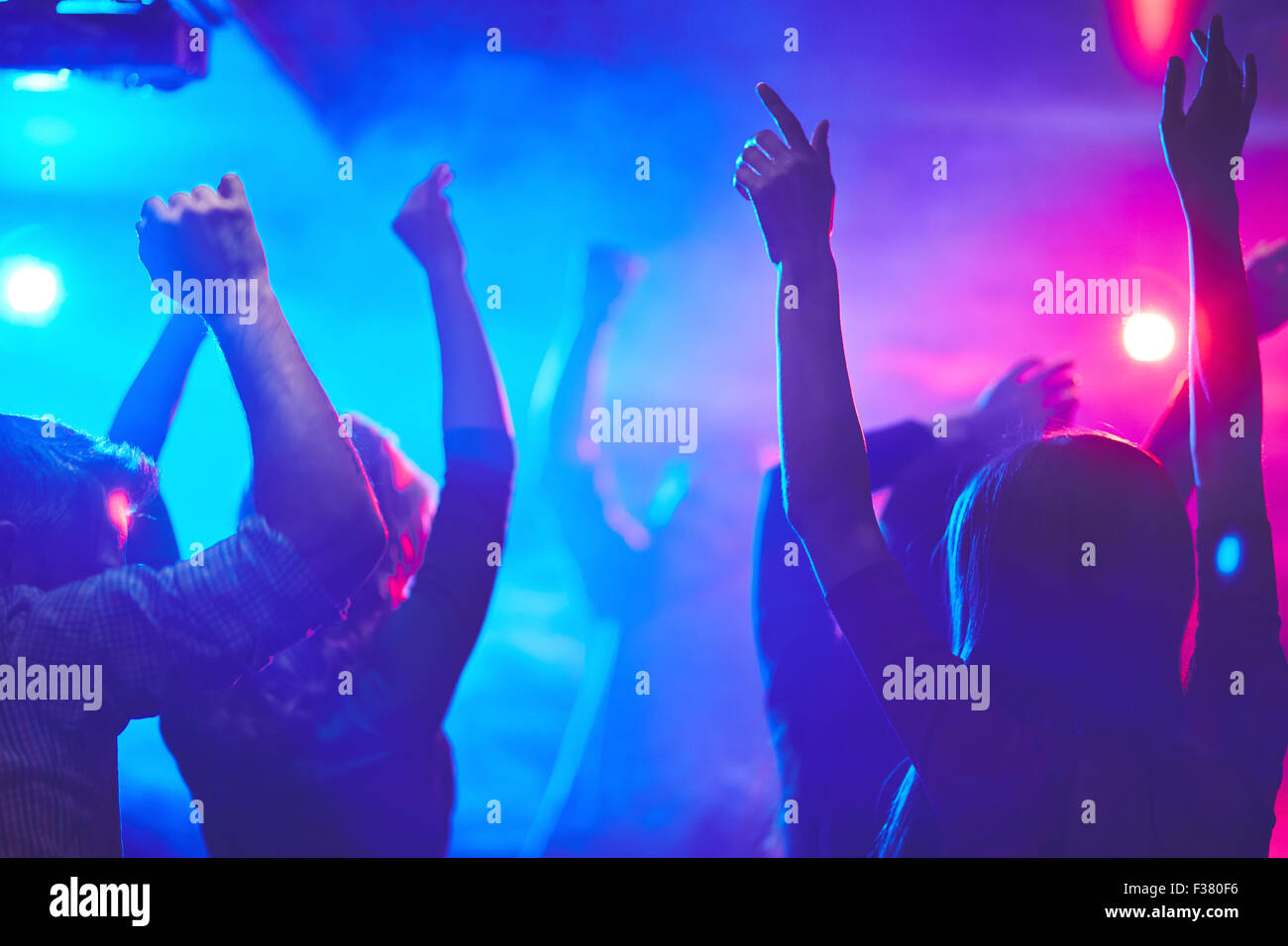 Group of dancing people with raised arms enjoying disco party Stock ...