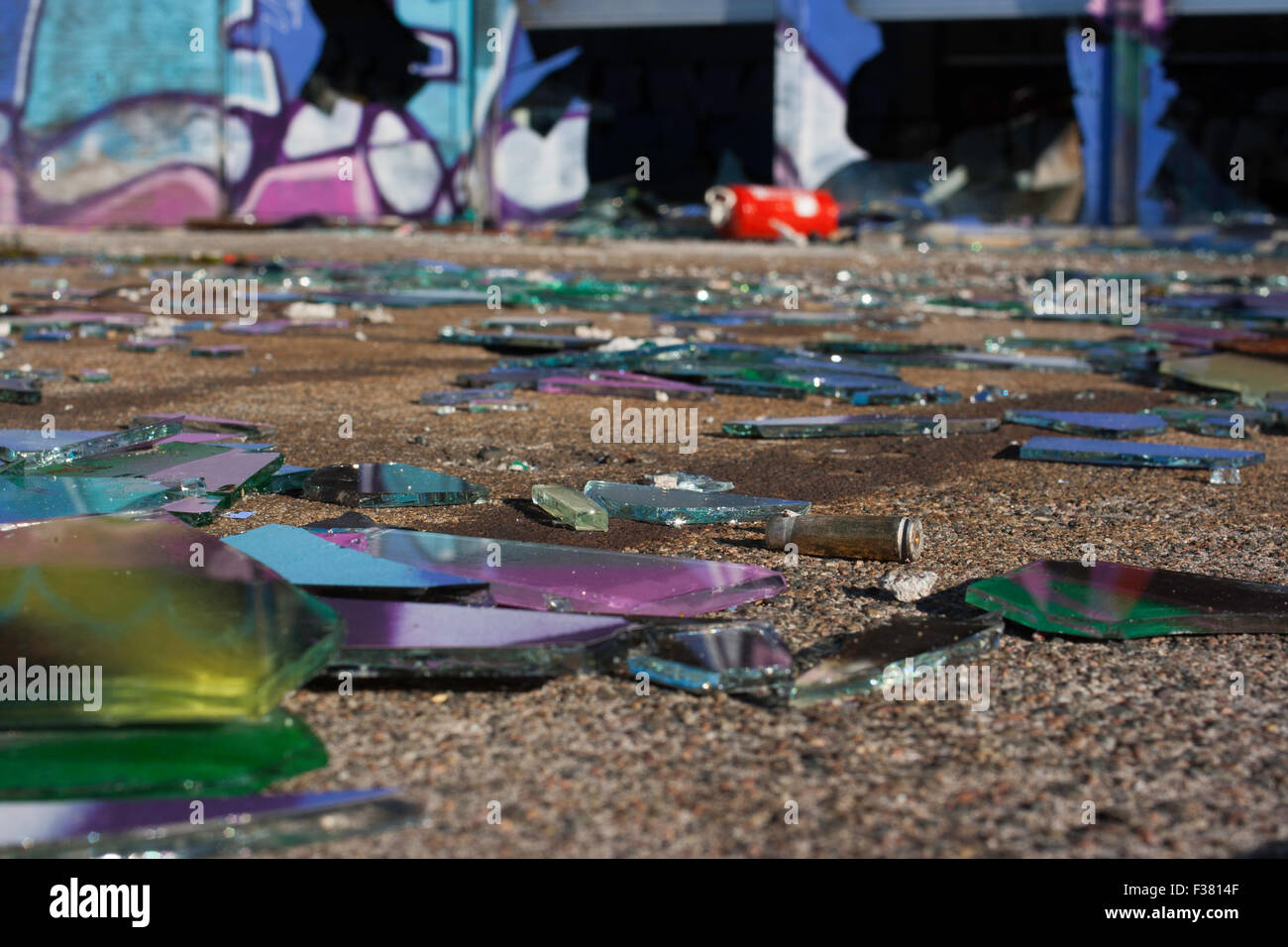 Pieces of broken glass and a shell of a bullet Stock Photo - Alamy