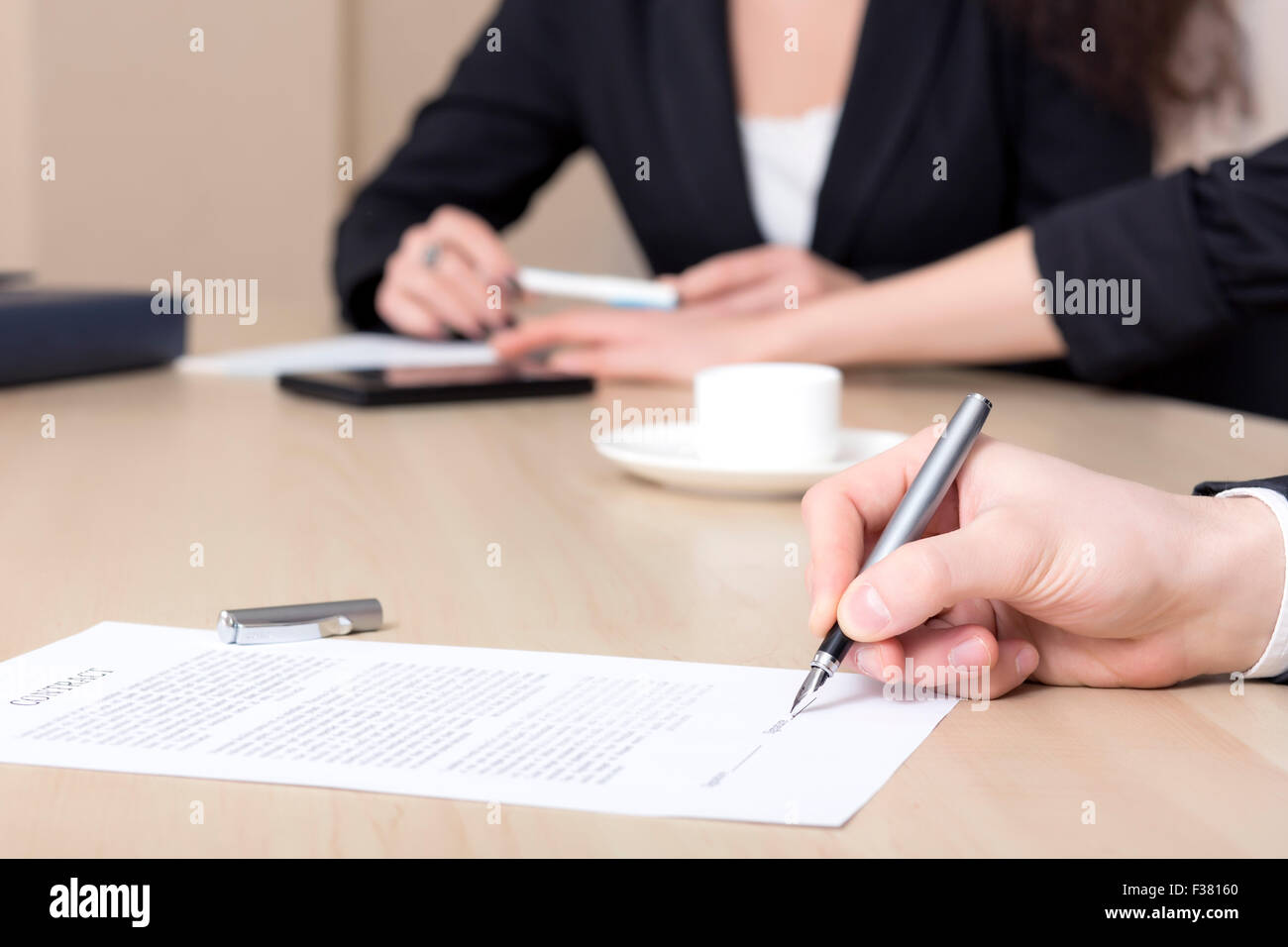 Female businessperson signs contract Stock Photo - Alamy