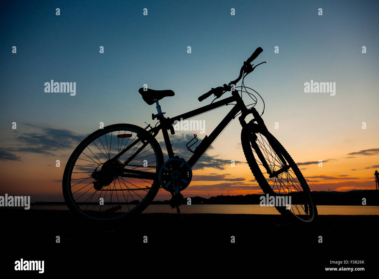 Bicycle at sunset Stock Photo - Alamy