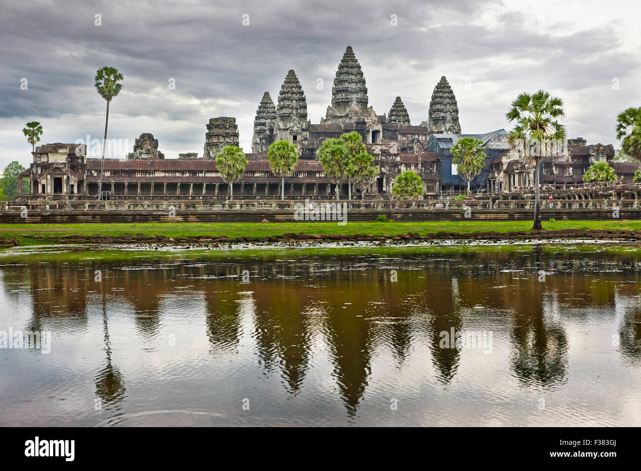 Iconic view of the Angkor Wat temple reflected in a nearby lake on a ...