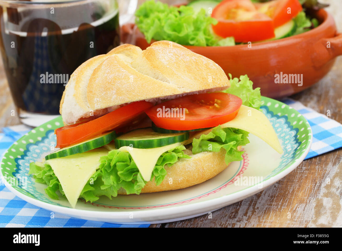 Bread roll with cheese, tomato, cucumber and lettuce, closeup Stock ...