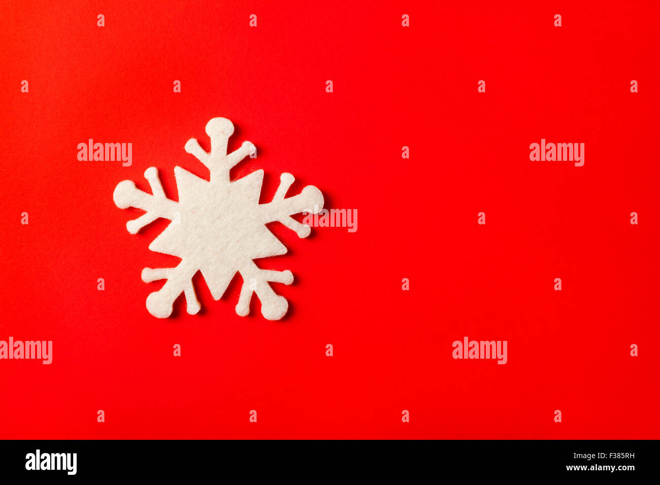 Christmas white snowflake on red background Stock Photo - Alamy