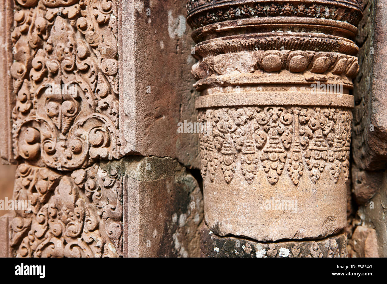 Fragment of a wall with ornate stone carving in the ancient Banteay ...