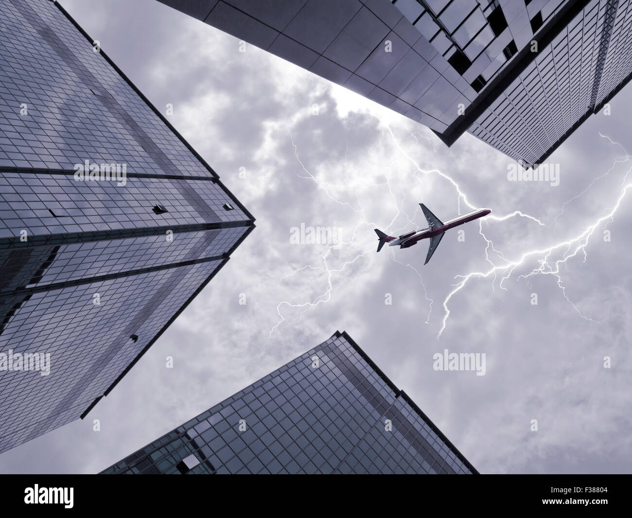 Bottom view of airplane flying above skyscraper in stormy sky Stock ...