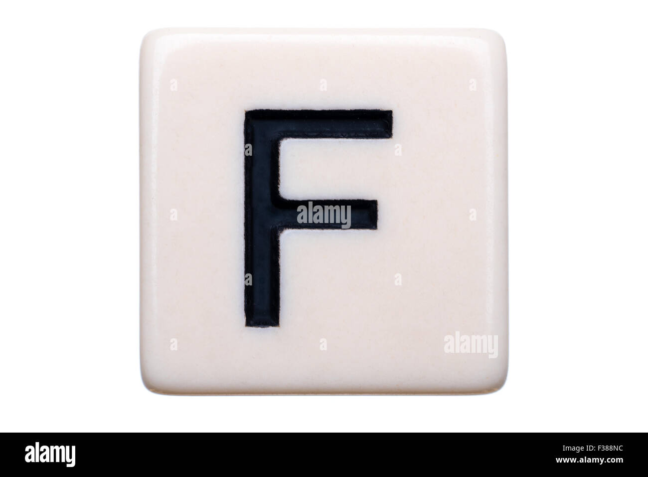 A macro shot of a game tile with the letter F on it on a white ...
