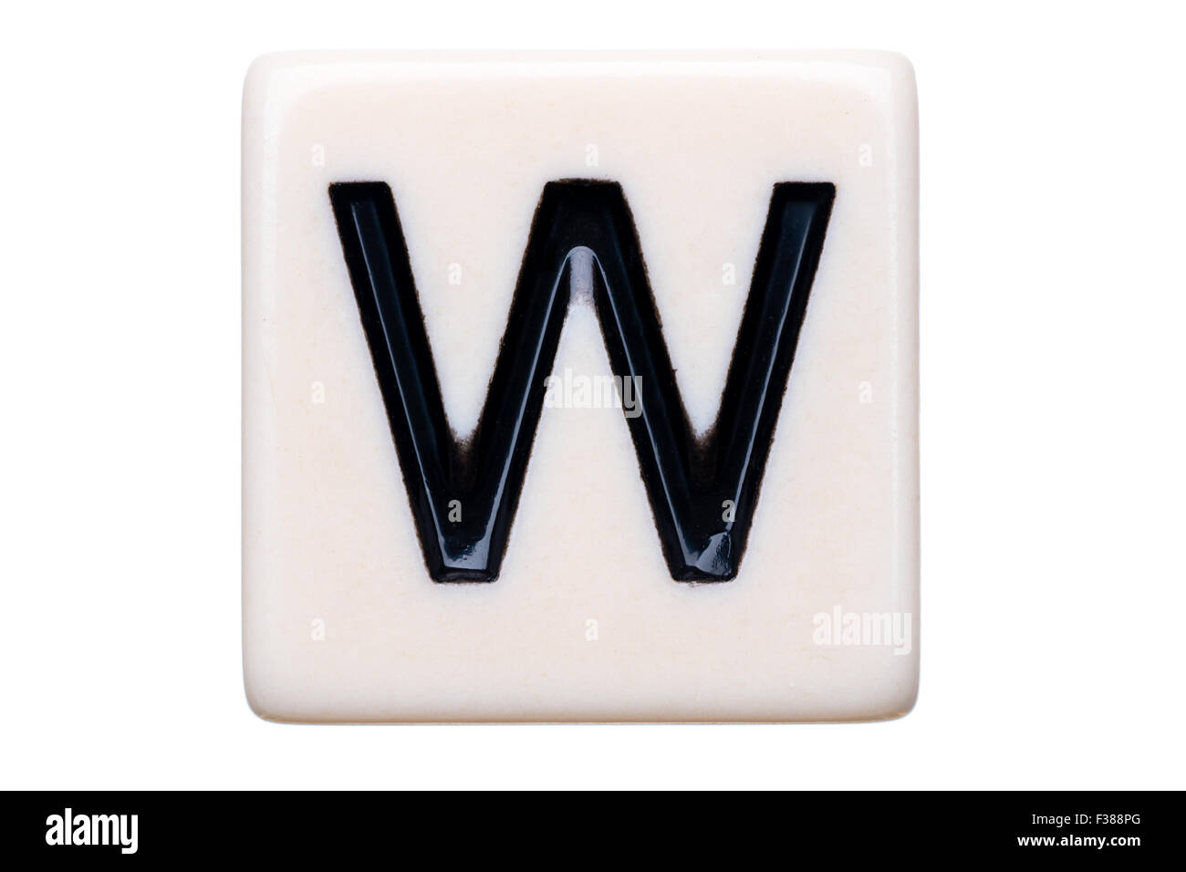 A macro shot of a game tile with the letter W on it on a white ...