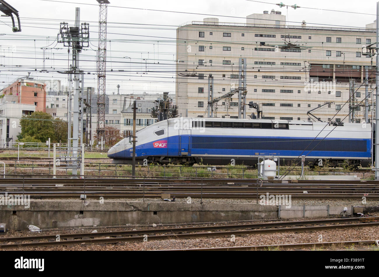 Blue high-speed train on a urban background Stock Photo - Alamy