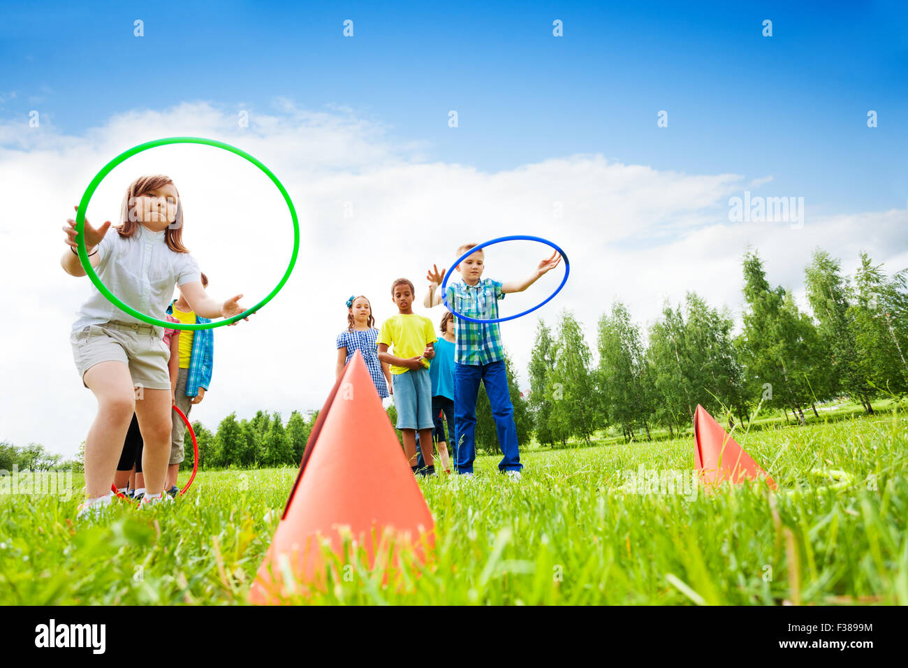 Two group of kids playing with hula hoops Stock Photo - Alamy