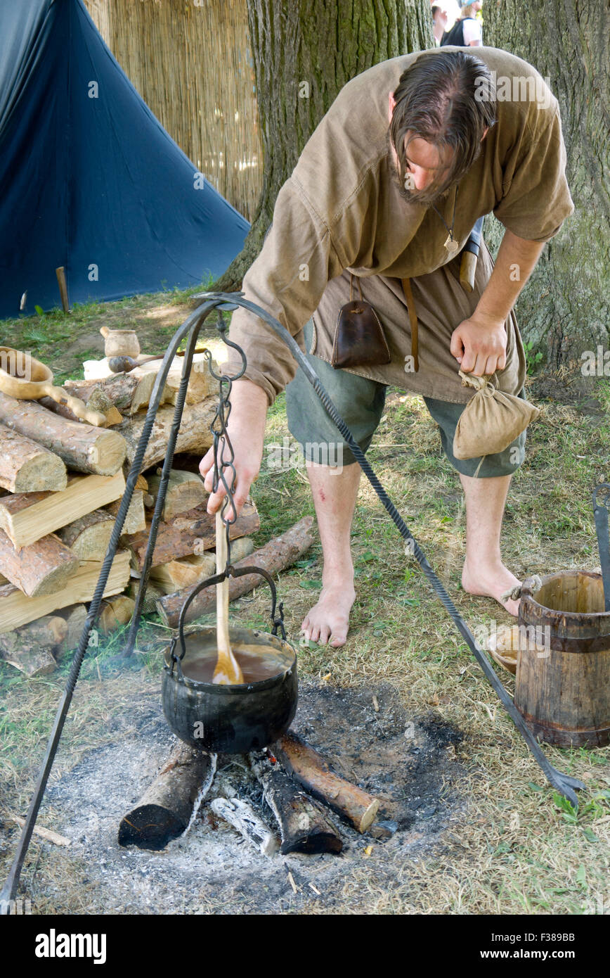 A man dressed in pagan clothes making mead Stock Photo - Alamy